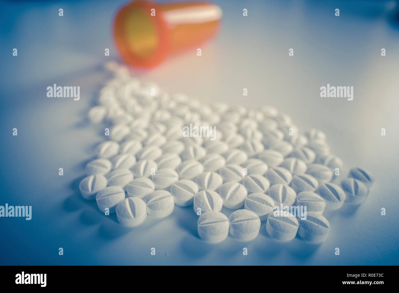 Tablets spilling from bottle Stock Photo - Alamy