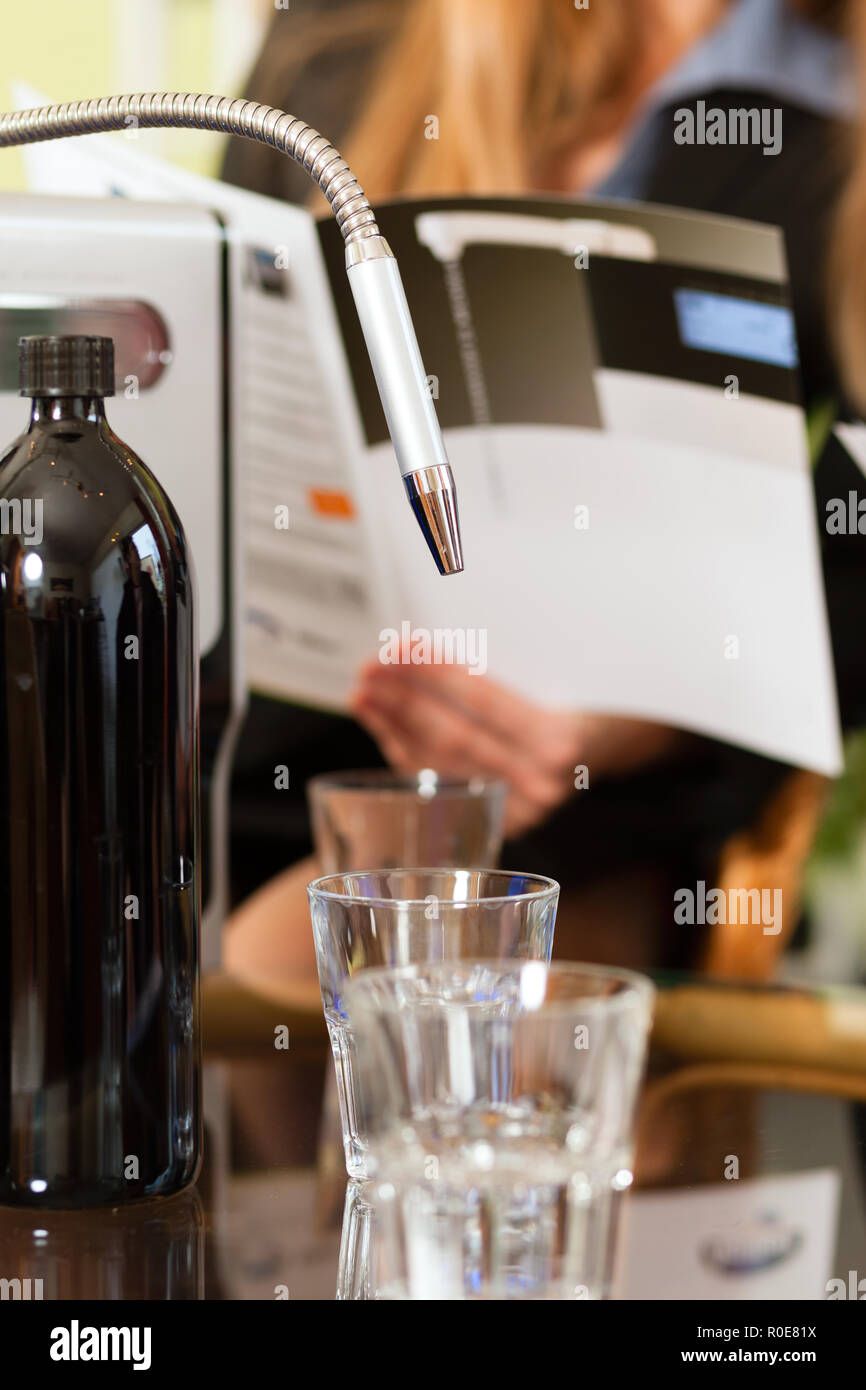 Modern alcohol faucet over the two glasses Stock Photo - Alamy