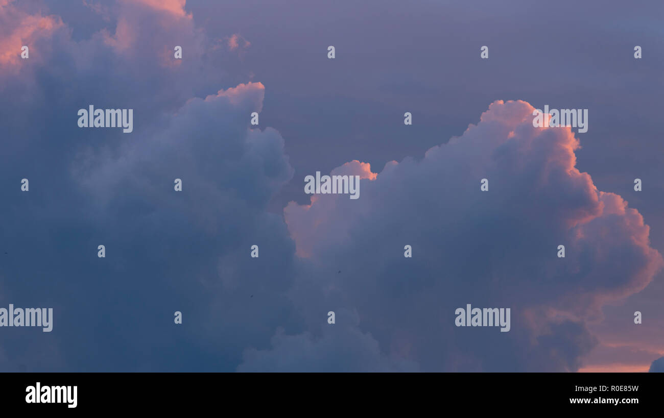 Cumulus type clouds on sunset with warm colors Stock Photo - Alamy