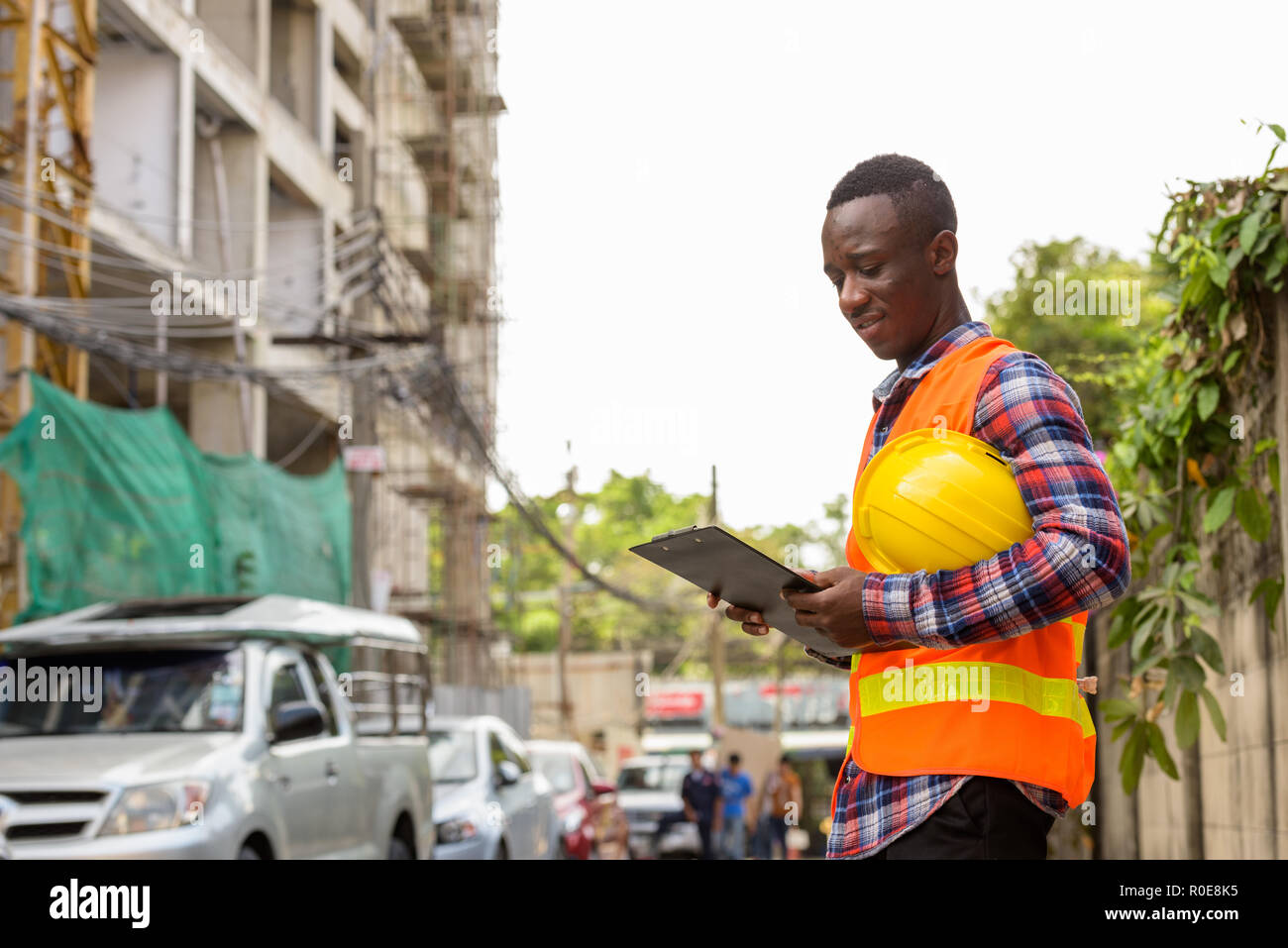 Young happy black African man construction worker smiling while Stock ...