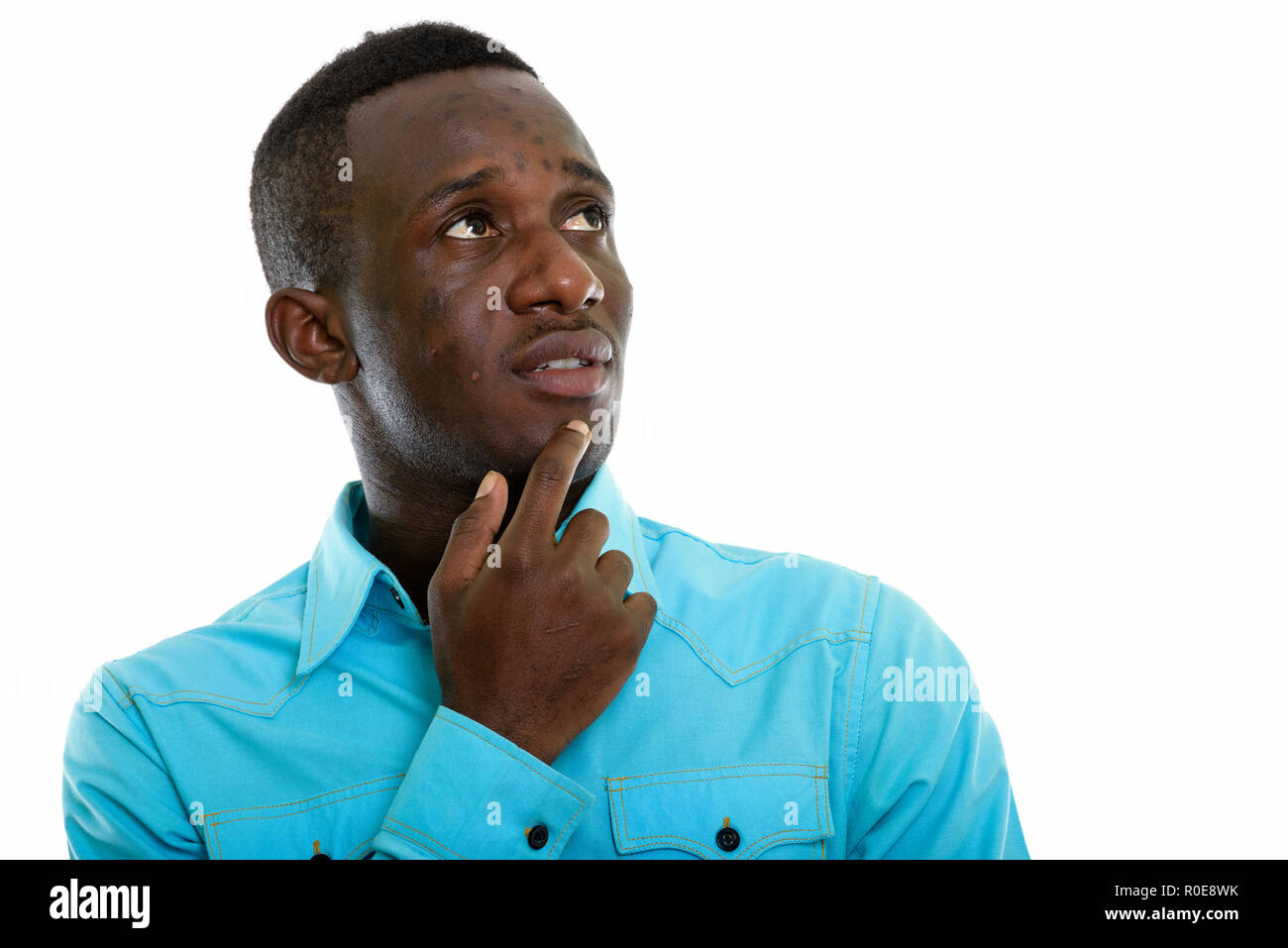 Close up of young black African man thinking while looking up Stock ...