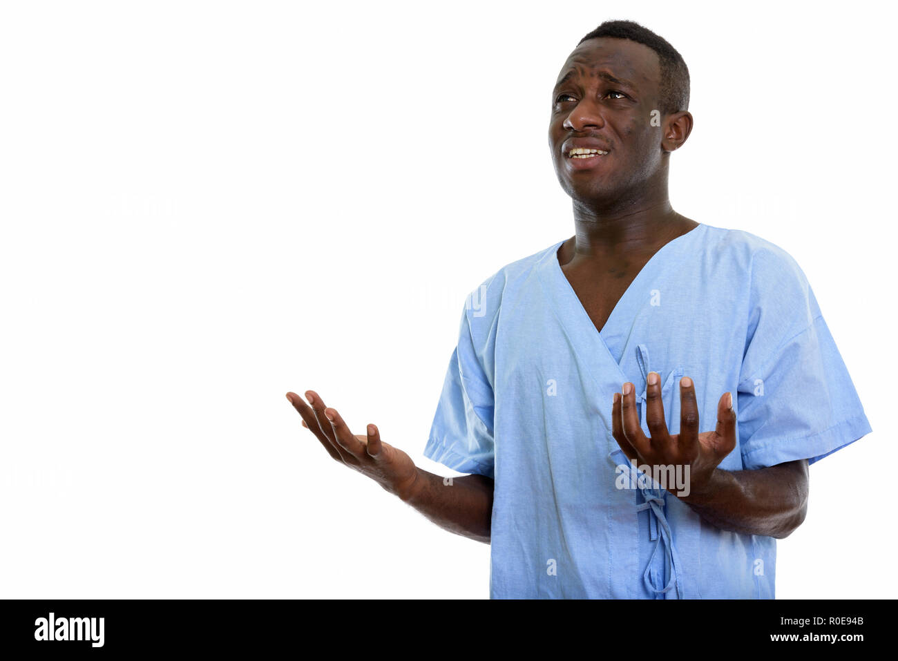 Studio shot of young black African man patient thinking while lo Stock ...