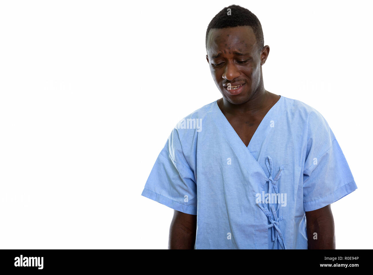 Studio shot of young black African man patient looking sad and c Stock ...
