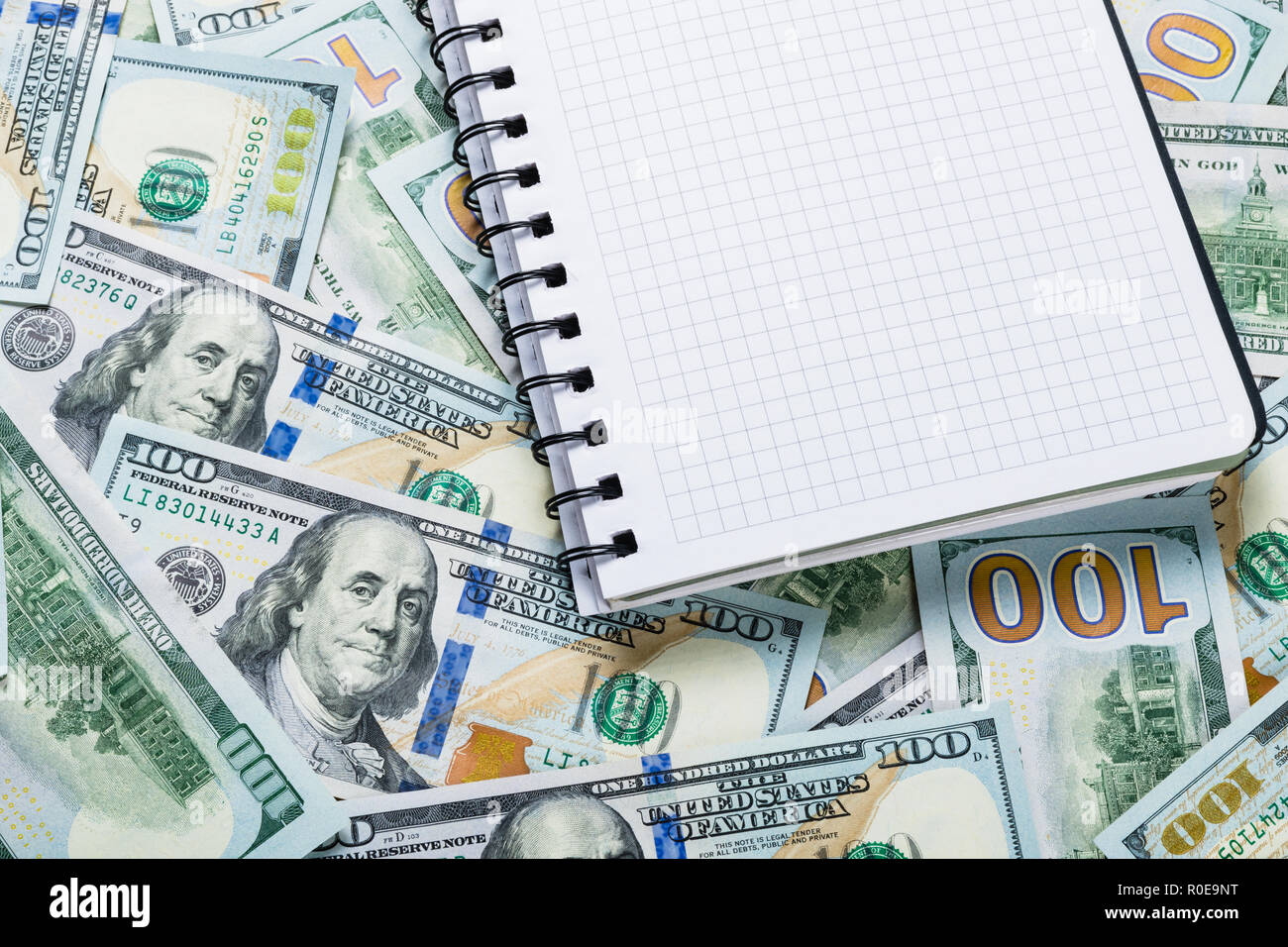 Notebook for notes lying on money background from one hundred dollars ...