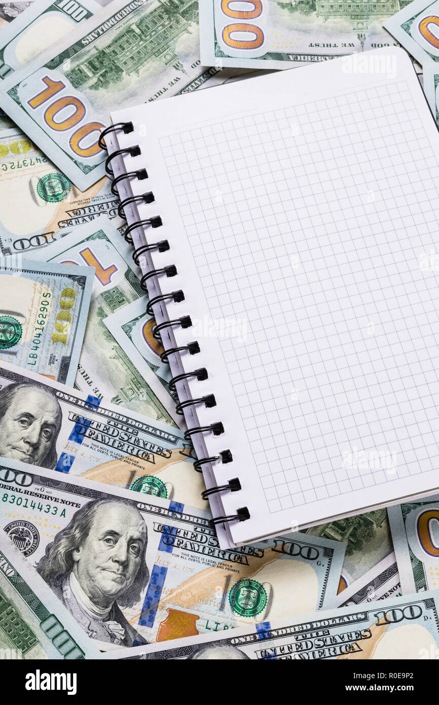 Notebook for notes lying on money background from one hundred dollars ...