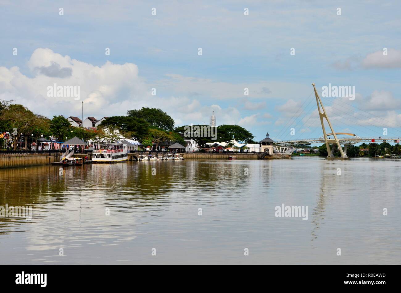 Sarawak river with modern bridge and cruise ship Kuching Borneo ...