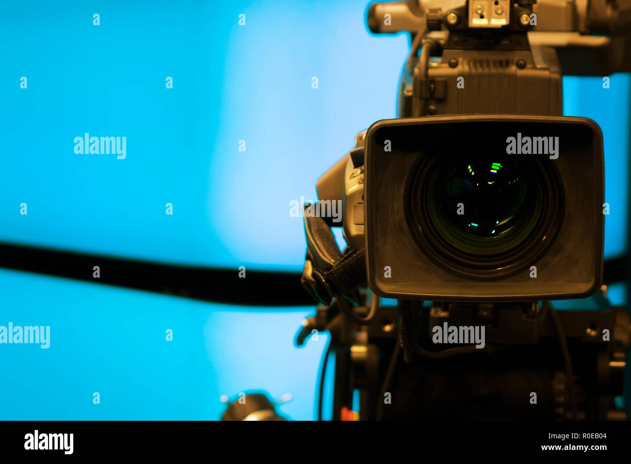Close-up of a Television Camera lens in a blue screen studio ...