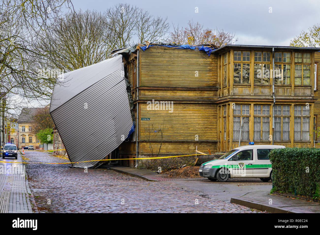 Yellow police tape surrounds this building following a severe storm ...