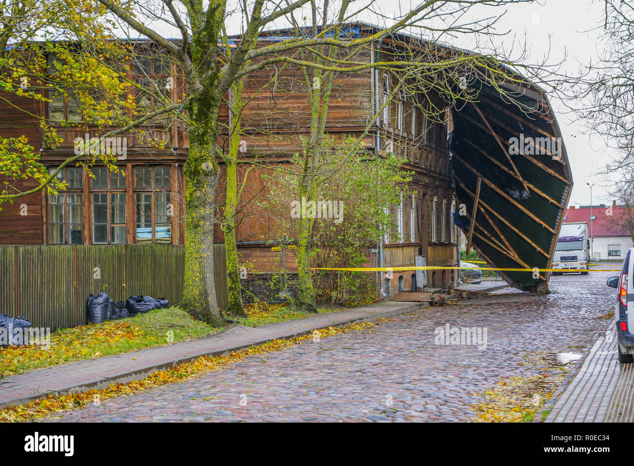 Yellow police tape surrounds this building following a severe storm ...