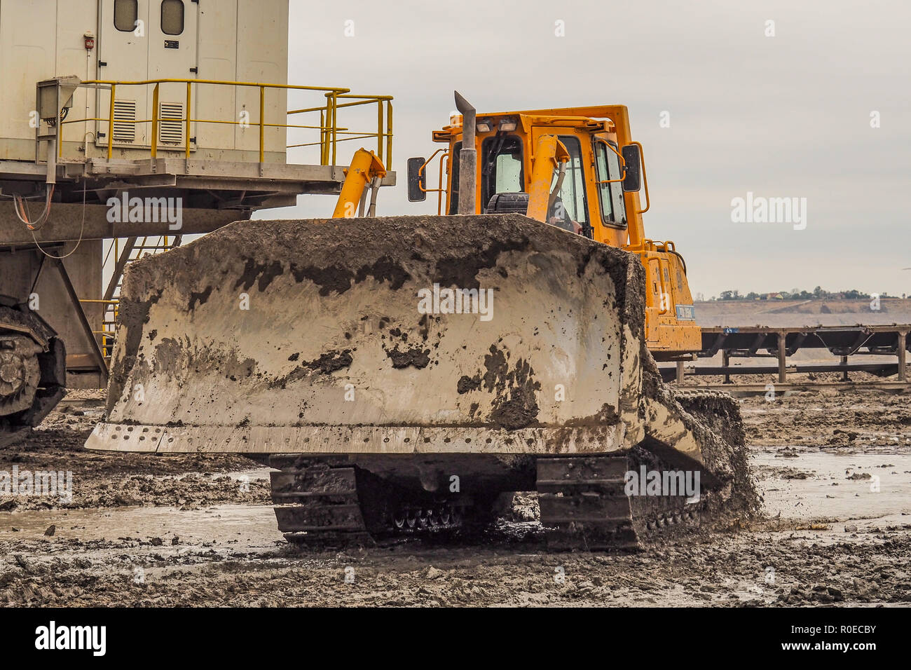 yellow bulldozer after work dirty from mud Stock Photo - Alamy