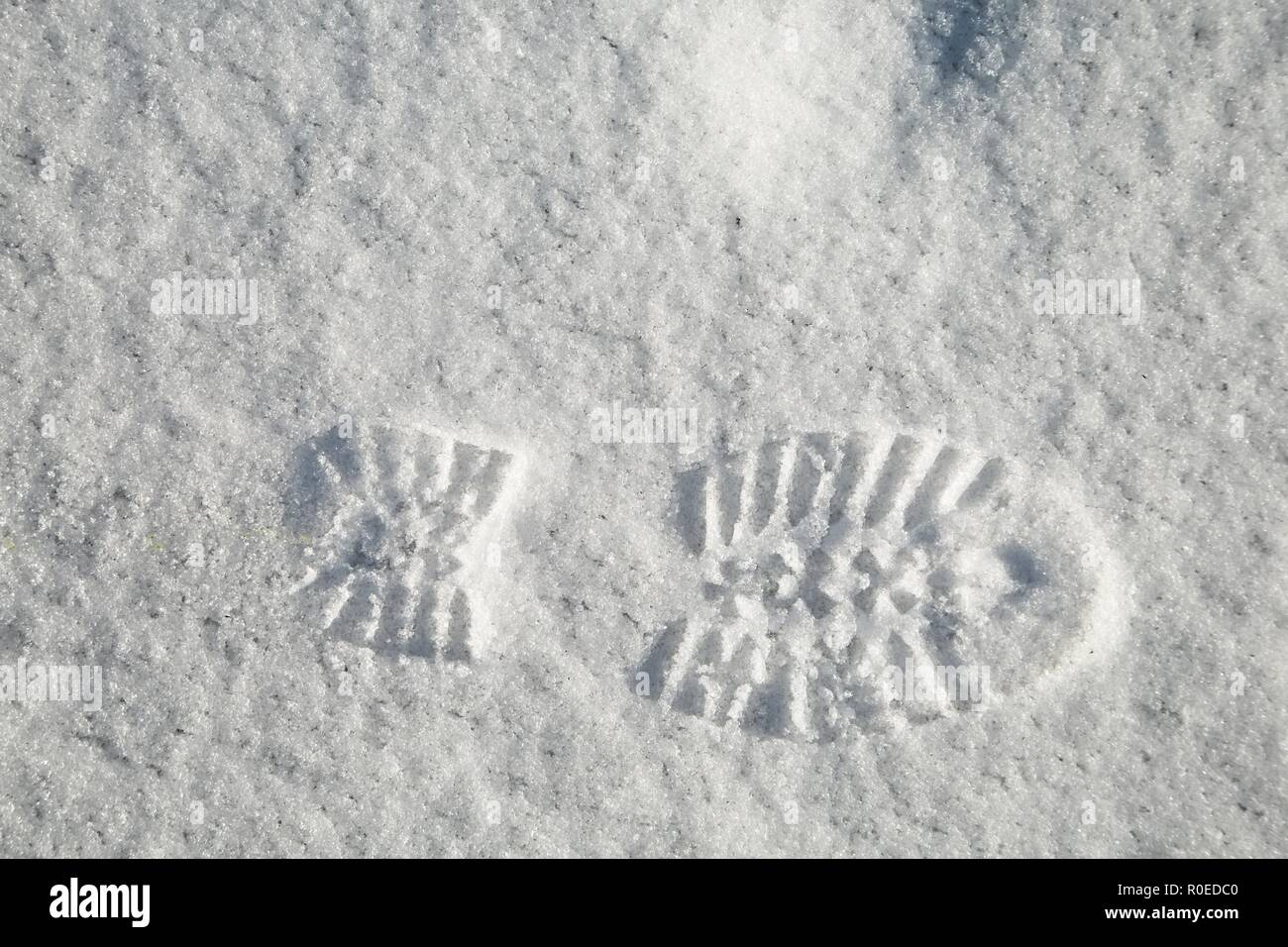 Footprint in snow Stock Photo - Alamy