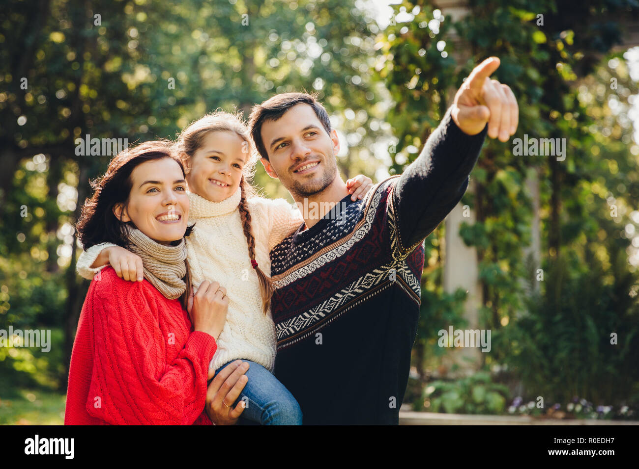 Outdoor portrait of smiling happy friendly family have walk together ...