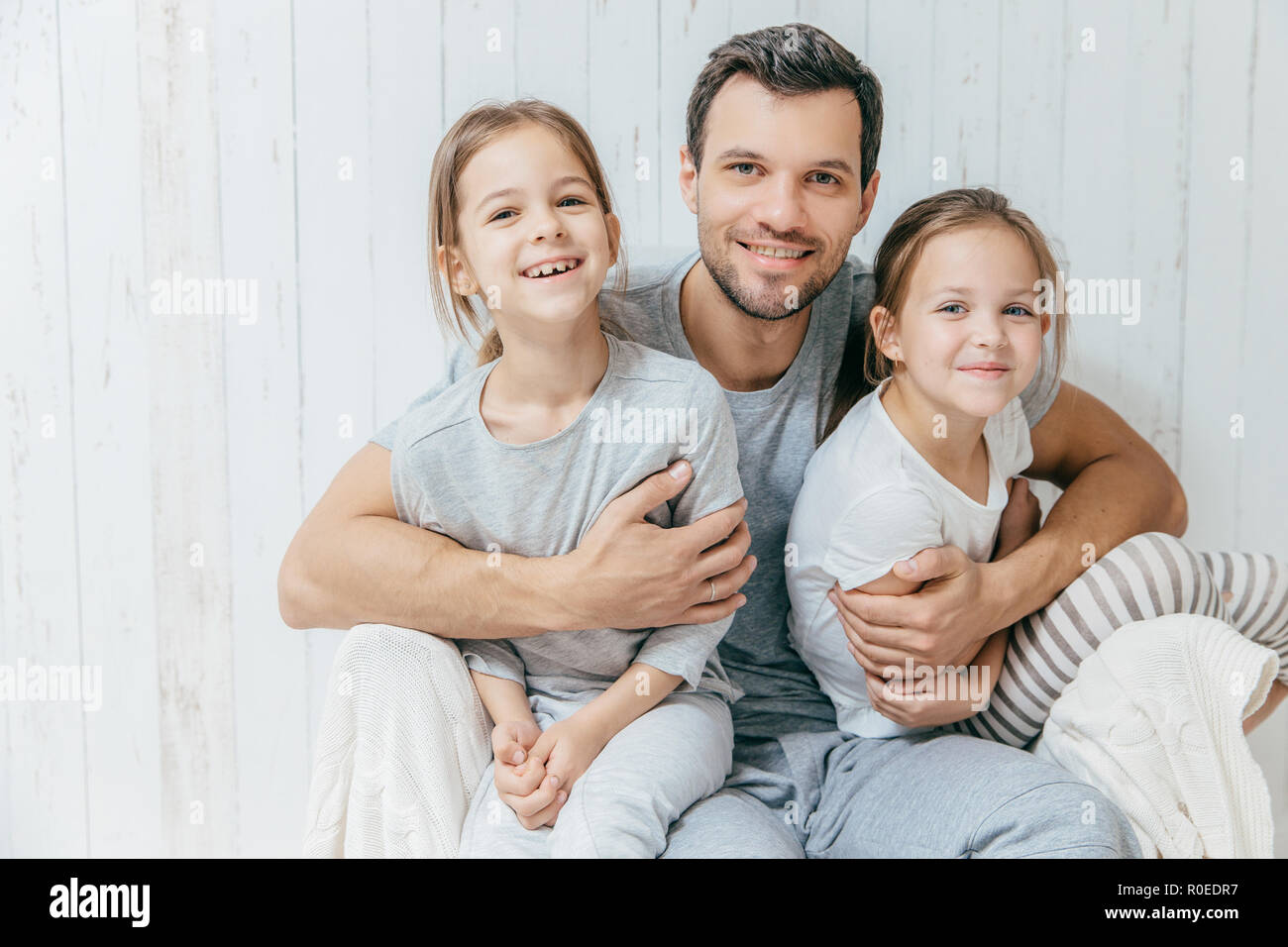 Father and kids. Paternity concept. Handsome unshaven affectionate dad ...