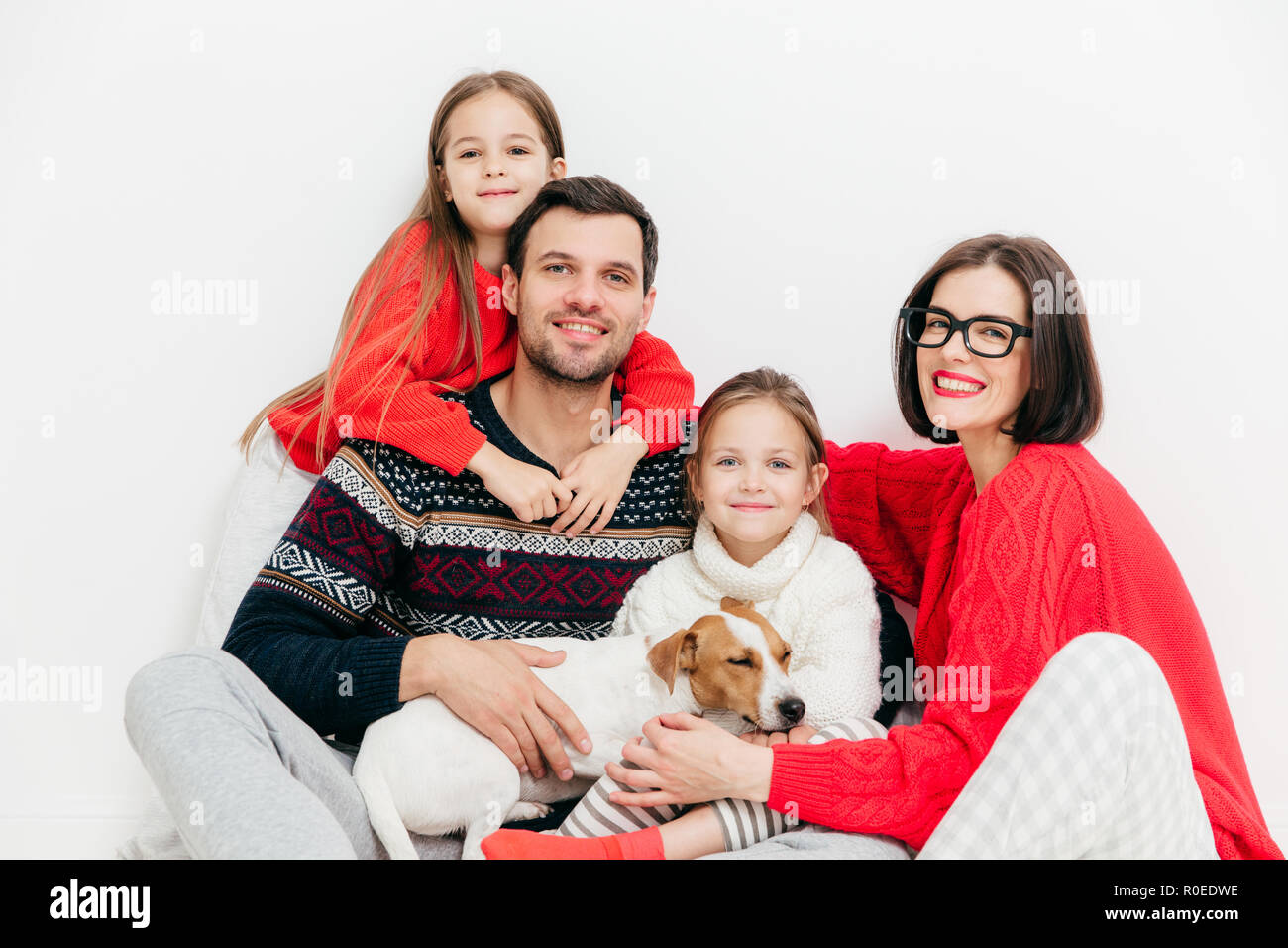 Portrait of happy family members with positive expressions, cuddle and ...