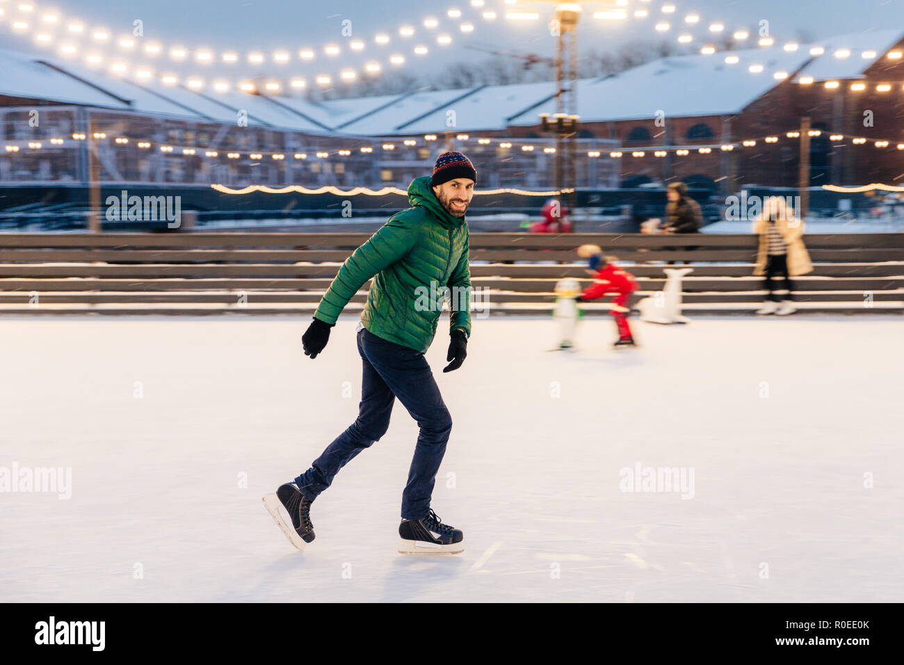 Professional male skater shows his skating talents, being sure on ice ...