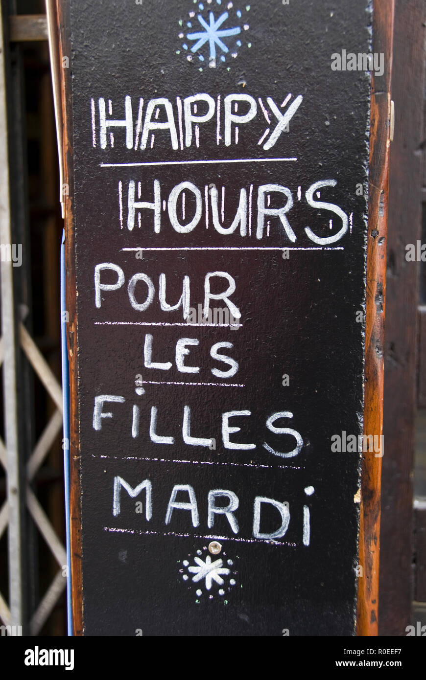 A "happy hour" sign at a bar on Rue Mouffetard, a popular street lined ...
