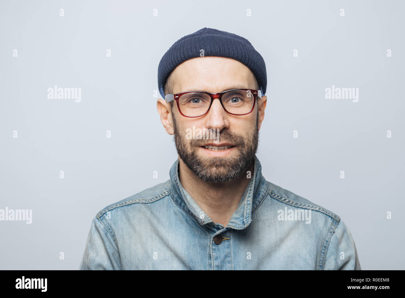 Portrait of handsome stylish male journalist wears eyewear, fashionable ...