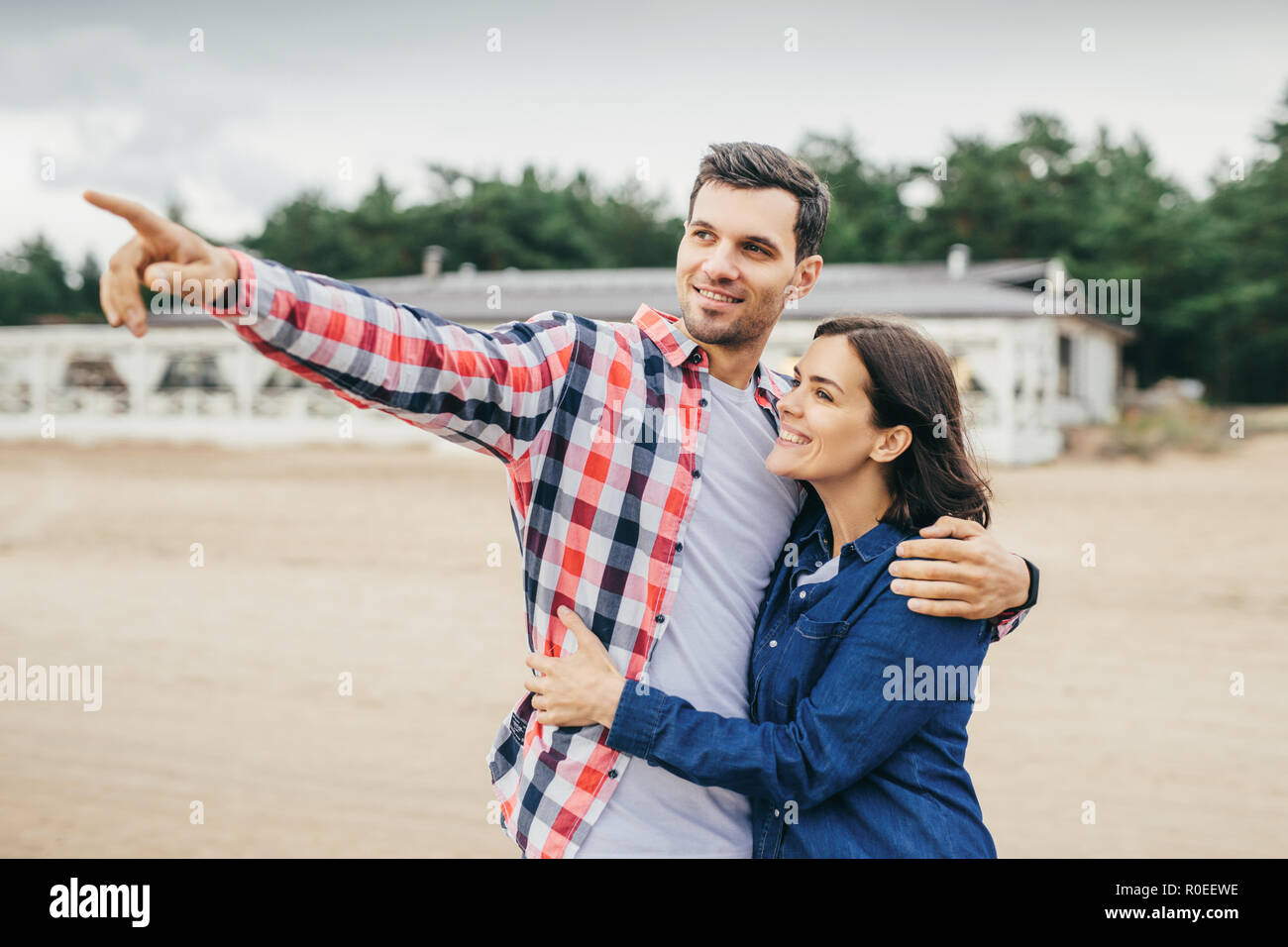Portrait of beautiful couple embrace each other, walk in city outdoor ...