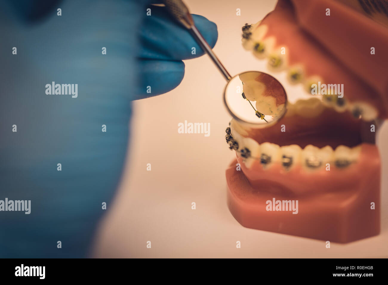 Detailed close up of dental instrument working on a denture or teeth ...