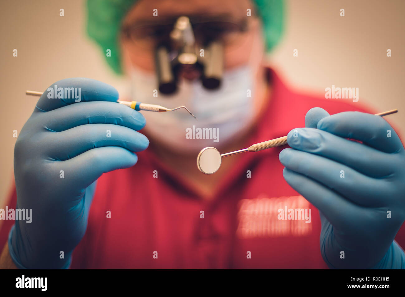 Dentist showing different dental instruments and tools with blue rubber ...