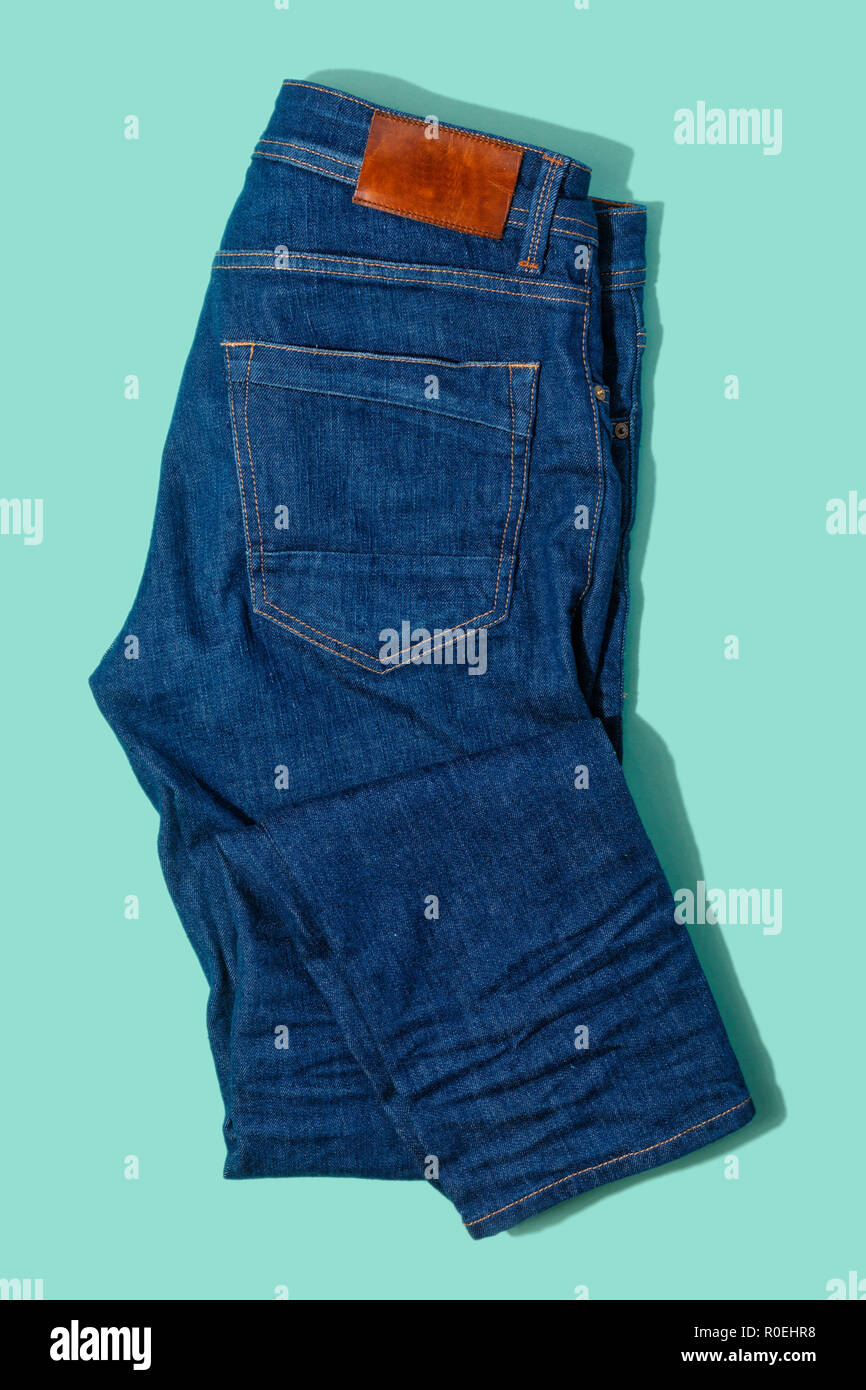 Flat lay male blue jeans on turquoise background top view Stock Photo ...