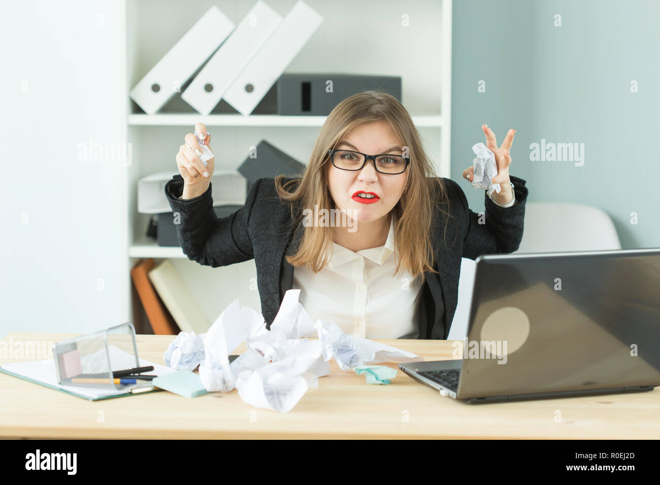 People, business and emotions concept - Angry woman sitting at desk in ...