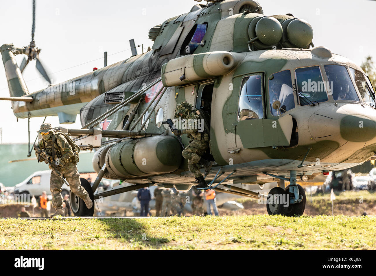 Military helicopter lands on the ground during Military Exercise Stock ...
