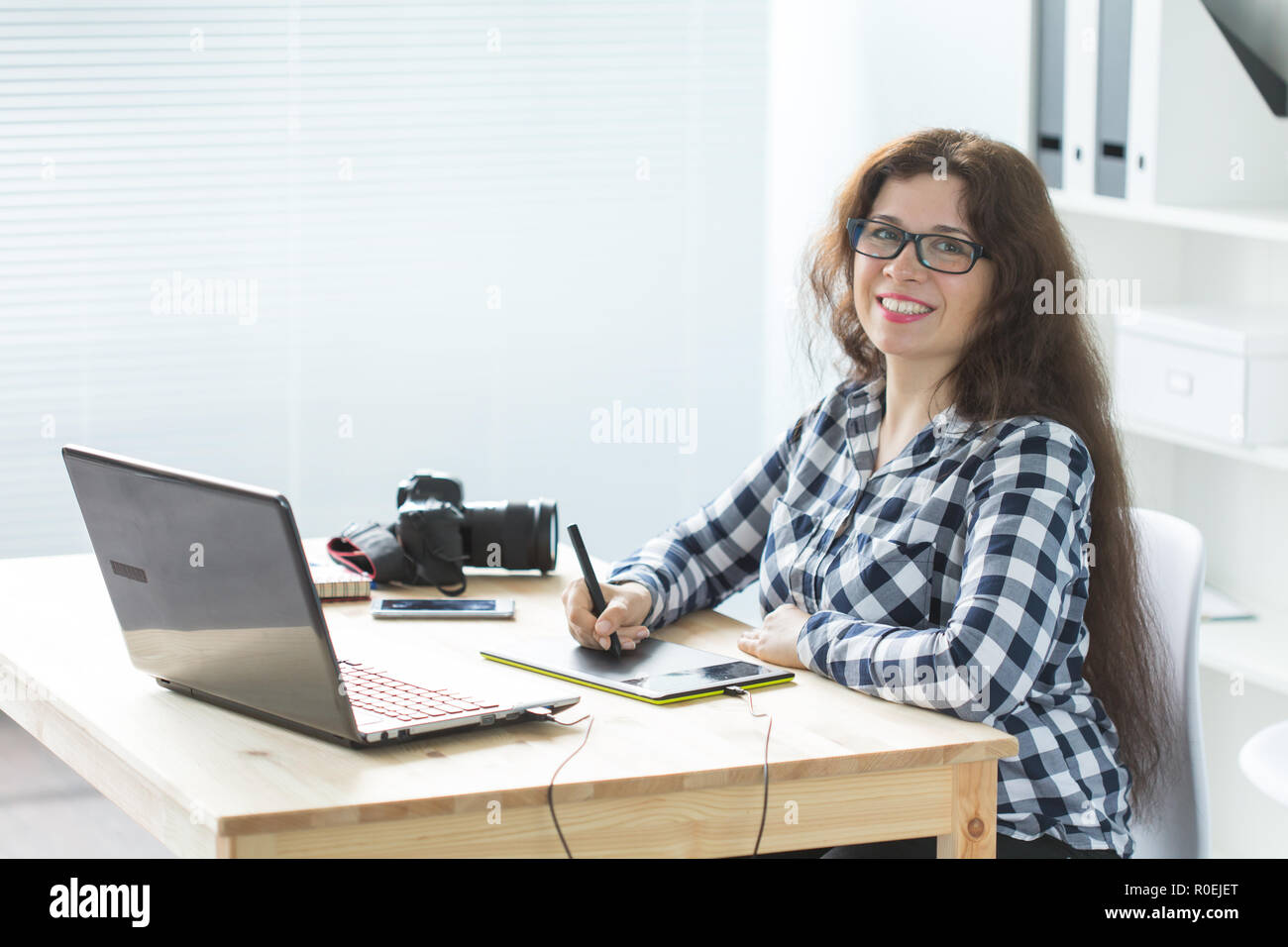 Business, web design and people concept - woman use graphic tablet in ...