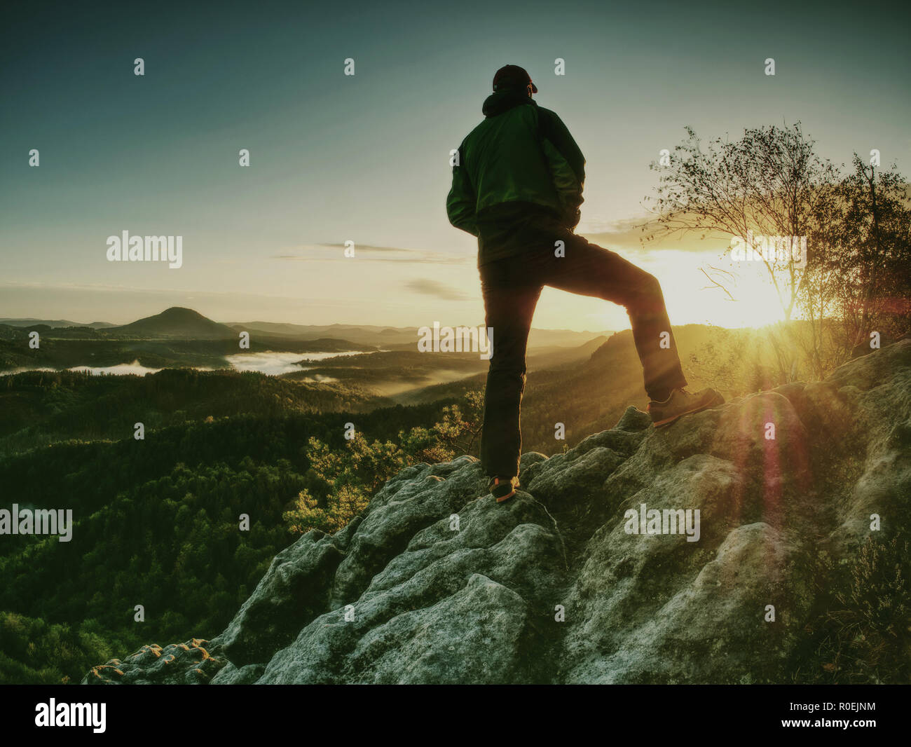 Man in rocks. Climbing hiking silhouette in fall mountains. The climber ...
