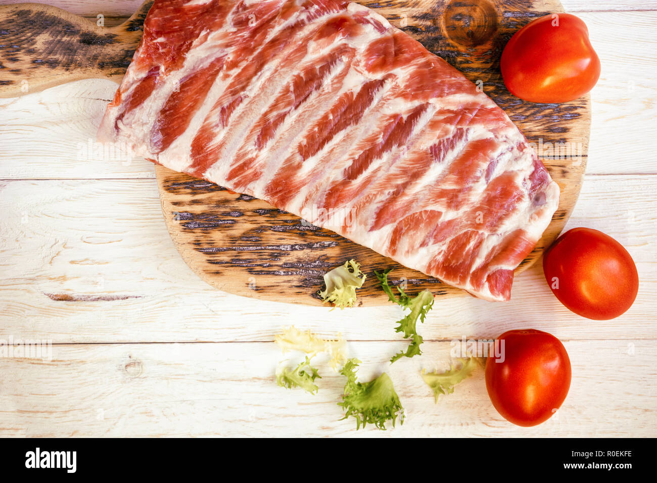 Raw meat ribs on the cutting board. Top view Stock Photo - Alamy