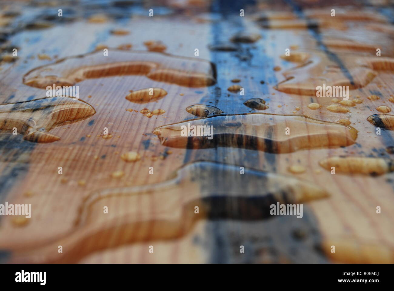 Large water drops on a desk Stock Photo - Alamy