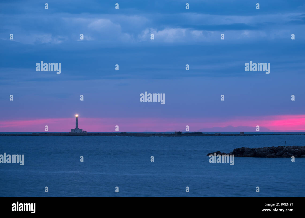 Lighthouse photographed against the sunset with pink sky, in Gallipoli ...