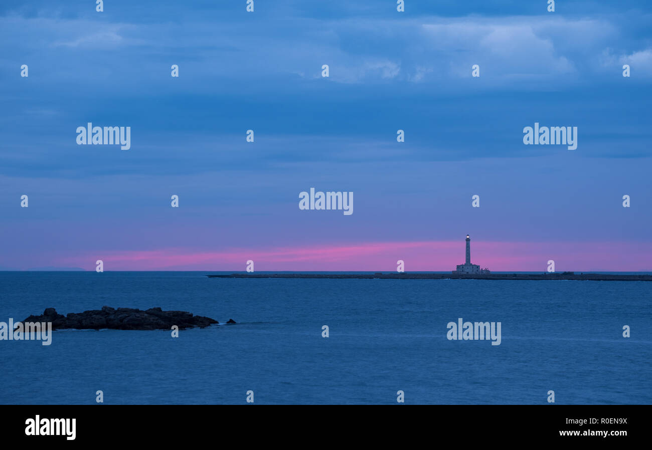 Lighthouse photographed against the sunset with pink sky, in Gallipoli ...