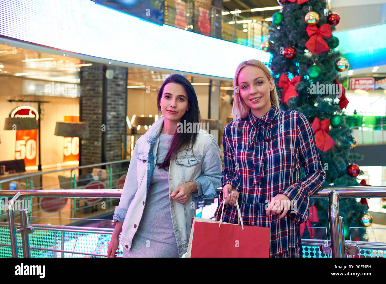 Two friends shopping on Christmas vacation Stock Photo - Alamy