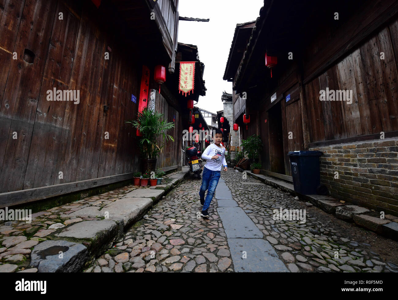 Shaowu. 4th Nov, 2018. A child runs through an alley in Heping Town of ...