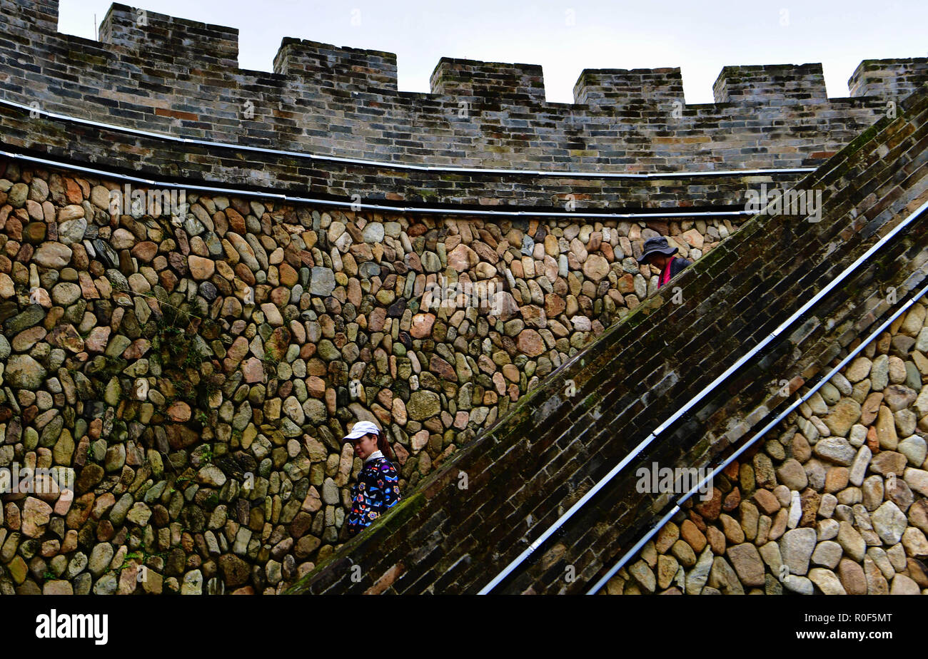 Shaowu. 4th Nov, 2018. Tourists walk down the watchtower of Heping Town ...