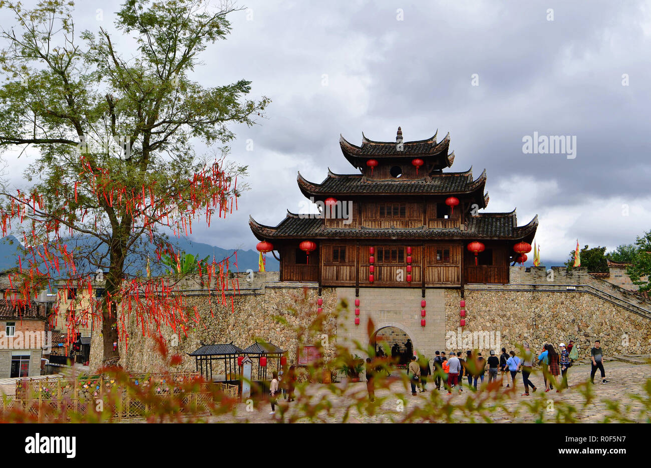 Shaowu. 4th Nov, 2018. Tourists walk around the watchtower of Heping ...