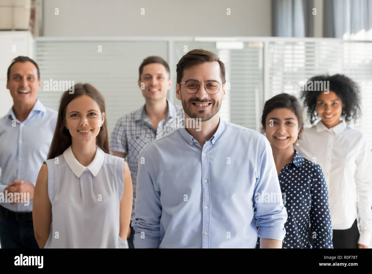 Happy colleagues looking camera office hi-res stock photography and ...
