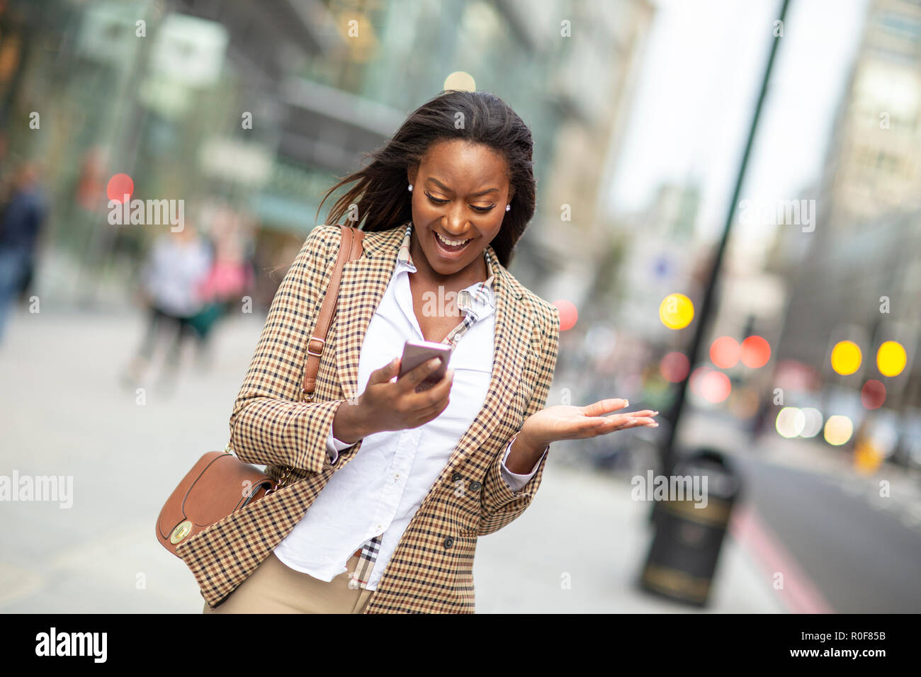 young business woman receiving a positive text message Stock Photo - Alamy