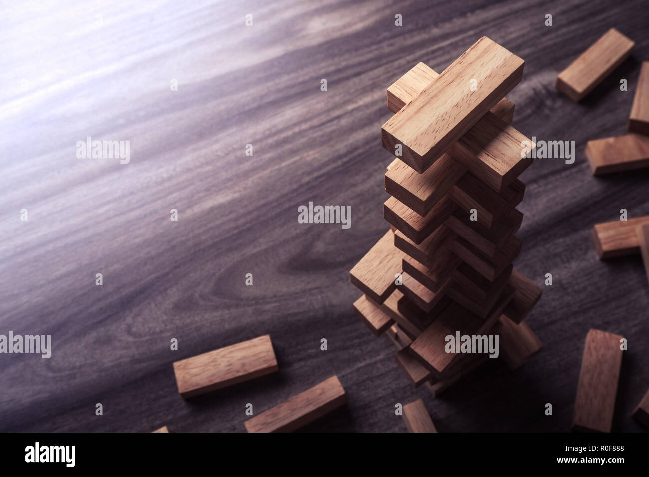 Wooden building blocks tower on wooden background top view with copy ...