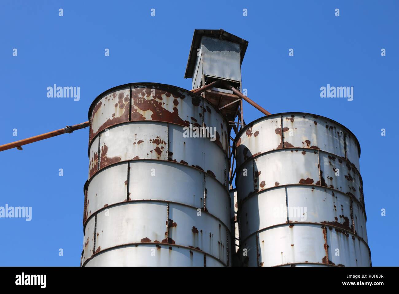 two old abandoned sheet silos once used as storage Stock Photo - Alamy