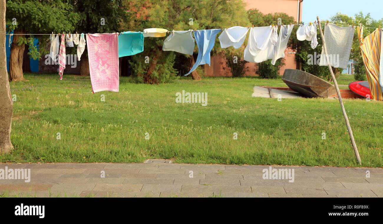 freshly washed laundry spread out to dry in a yard Stock Photo - Alamy