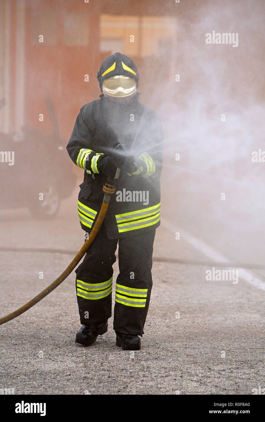 firefighter uses a powerful foaming agent to extinguish a large fire ...