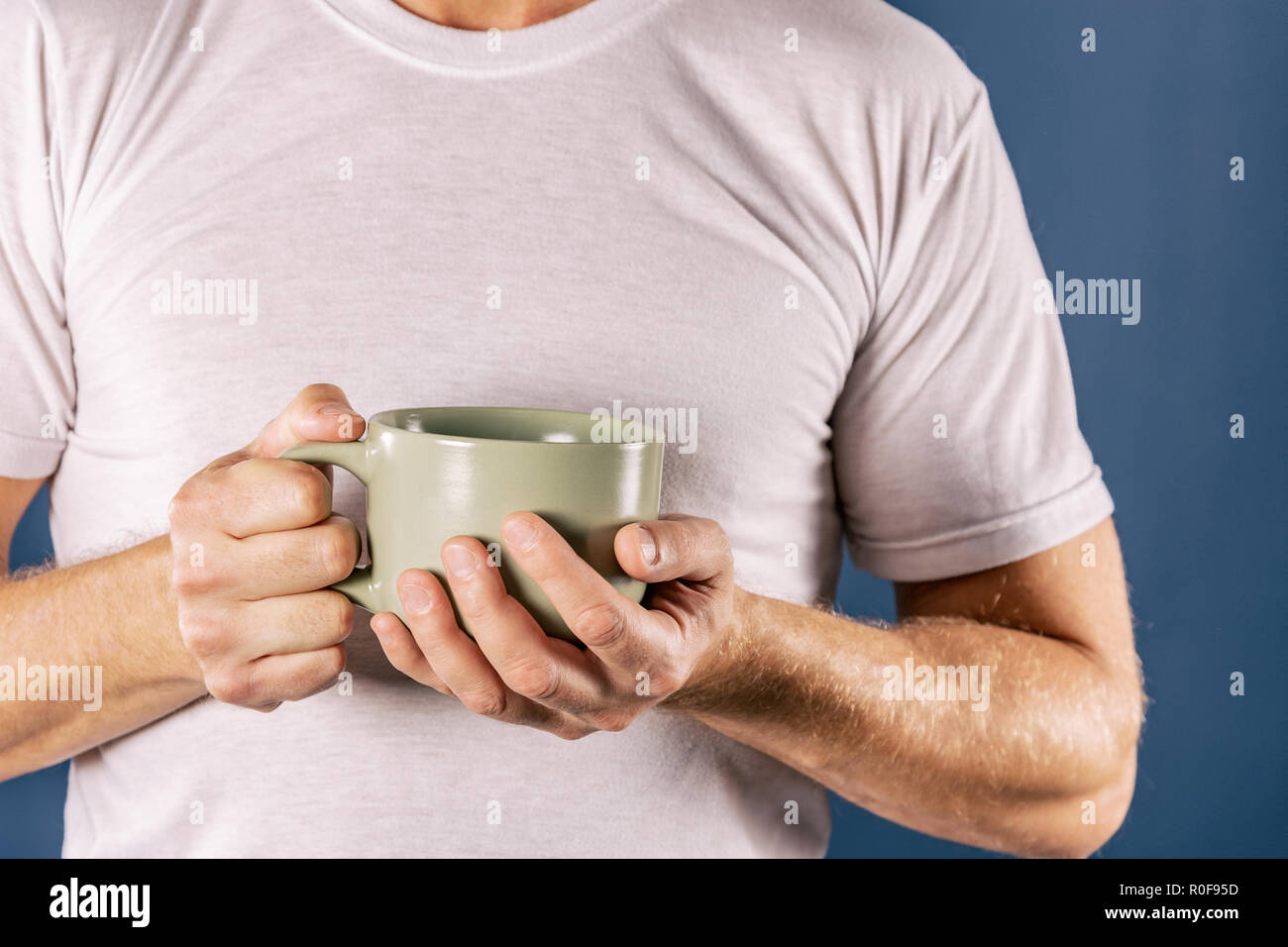 Sleepy man with a mug of coffee Stock Photo - Alamy