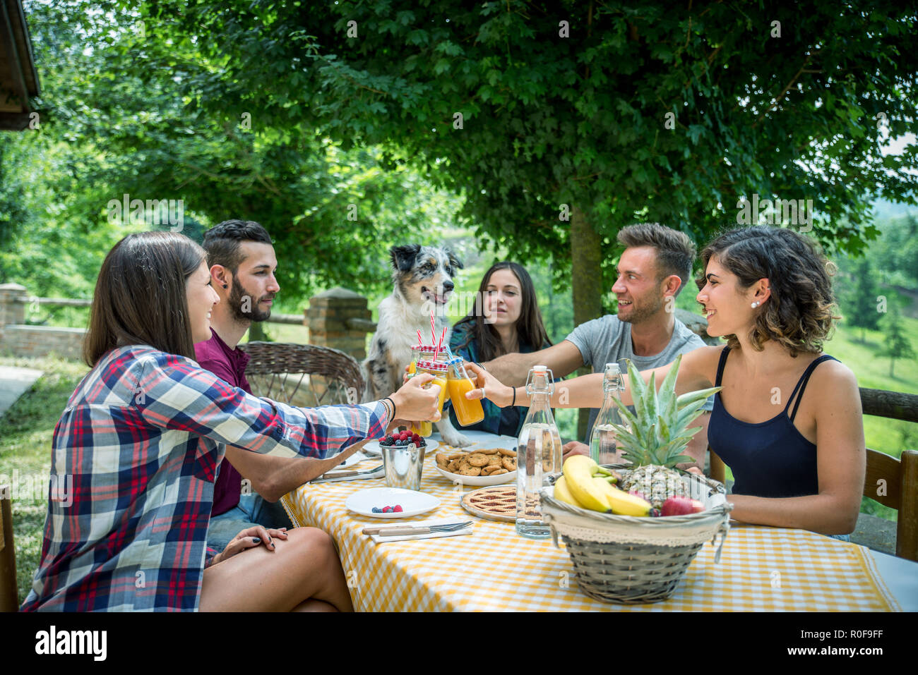 Group of happy people doing breakfast outdoors in a traditional ...