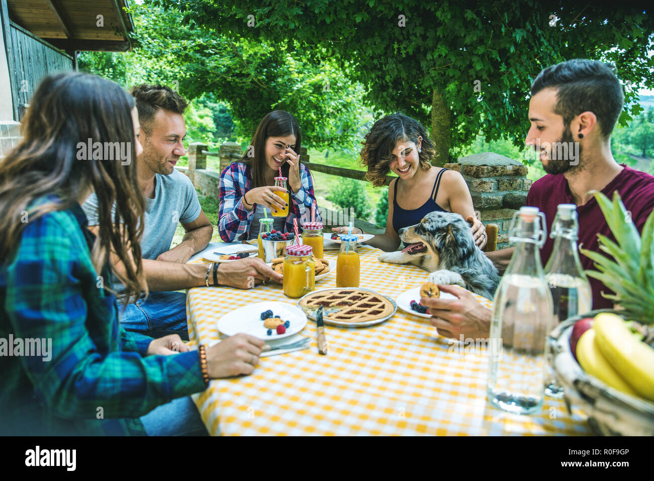 Group of happy people doing breakfast outdoors in a traditional ...