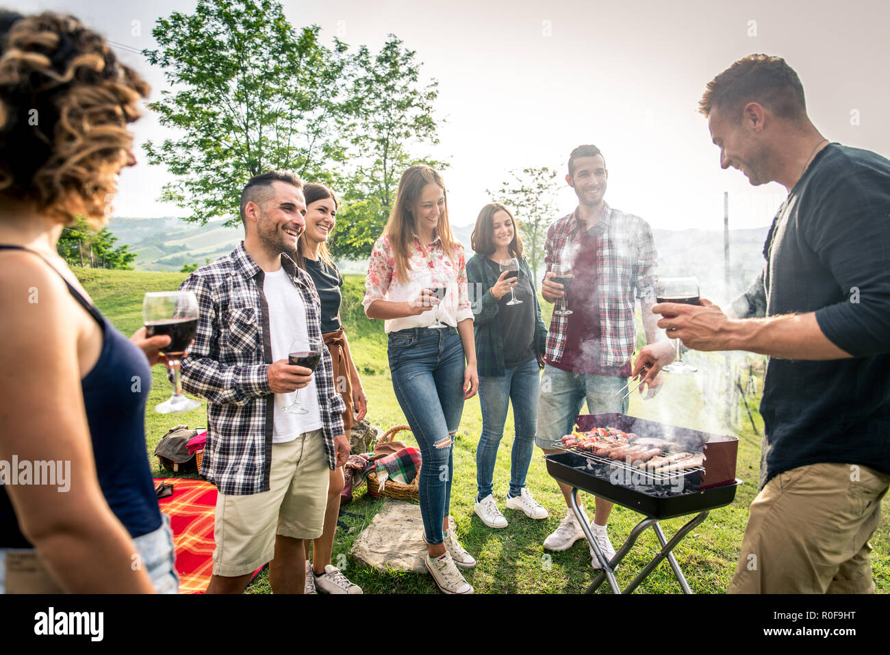 Group of young happy friends having pic-nic outdoors - People having ...