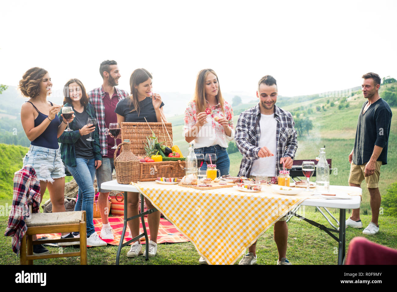 Group of young happy friends having pic-nic outdoors - People having ...