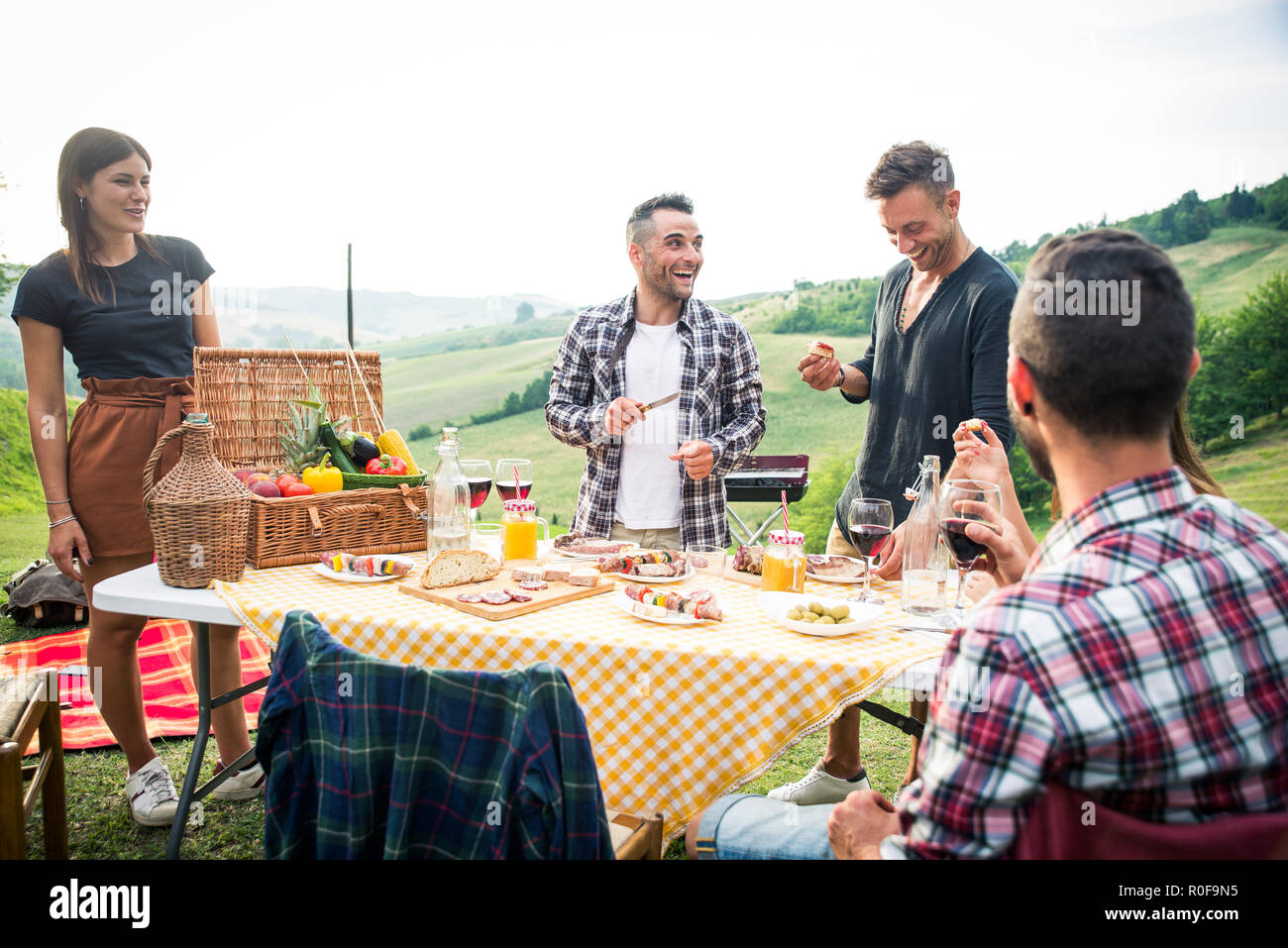 Group of young happy friends having pic-nic outdoors - People having ...