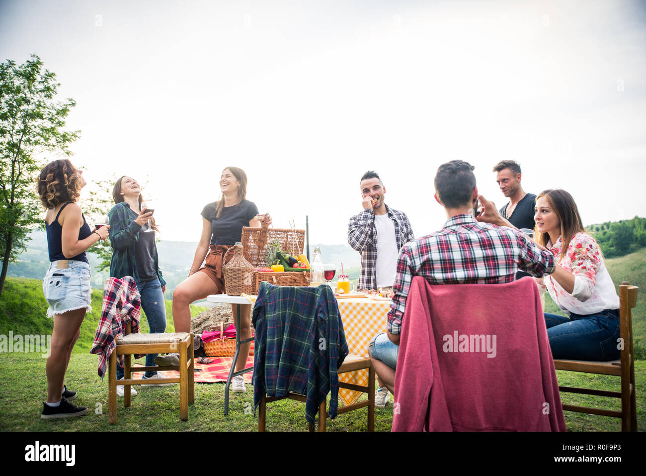 Group of young happy friends having pic-nic outdoors - People having ...